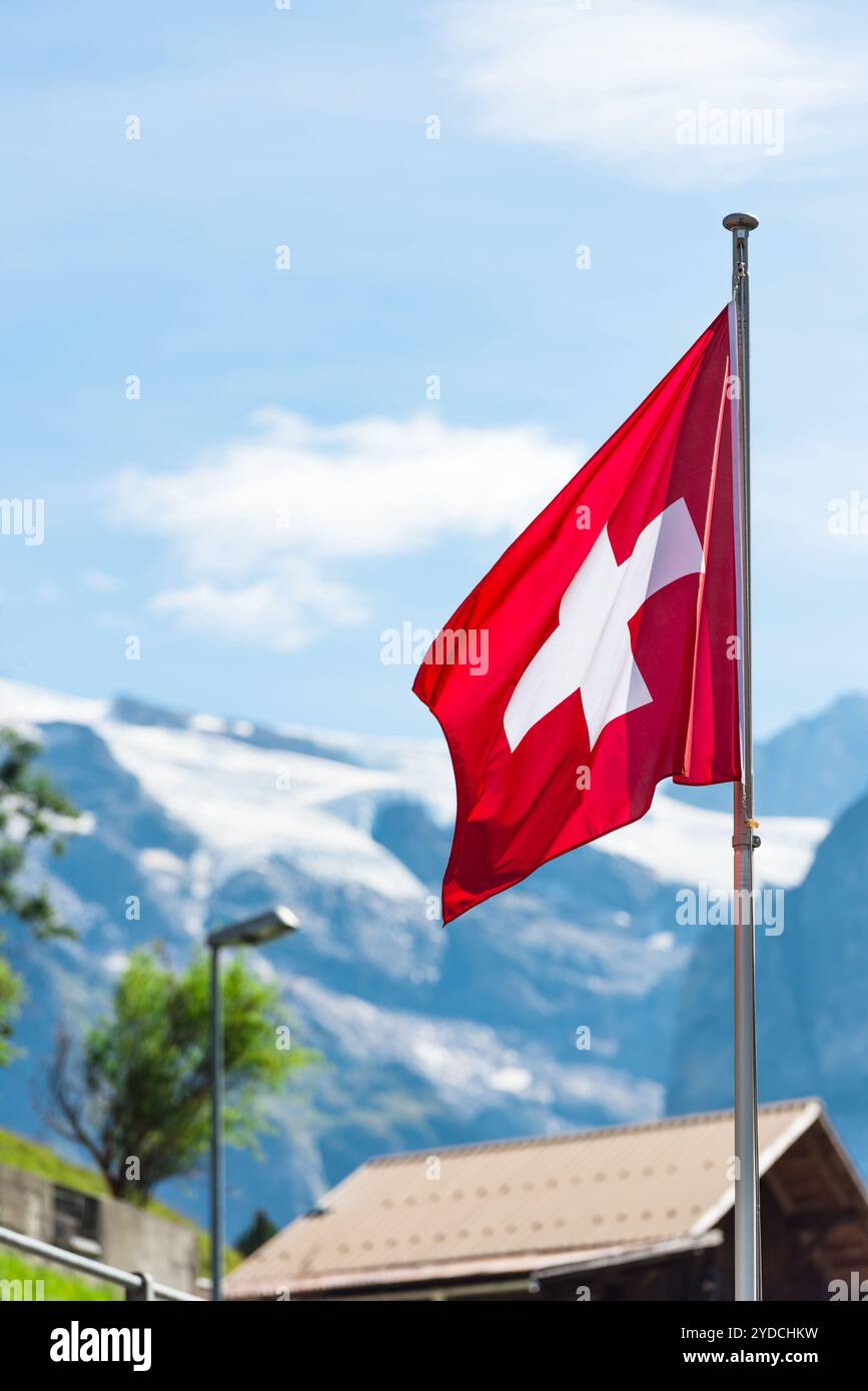 Swiss flag against Alps mountains Stock Photo - Alamy
