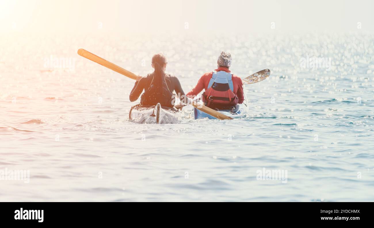 Kayaking Couple Water Sunset - Two people in kayaks paddling on calm ...