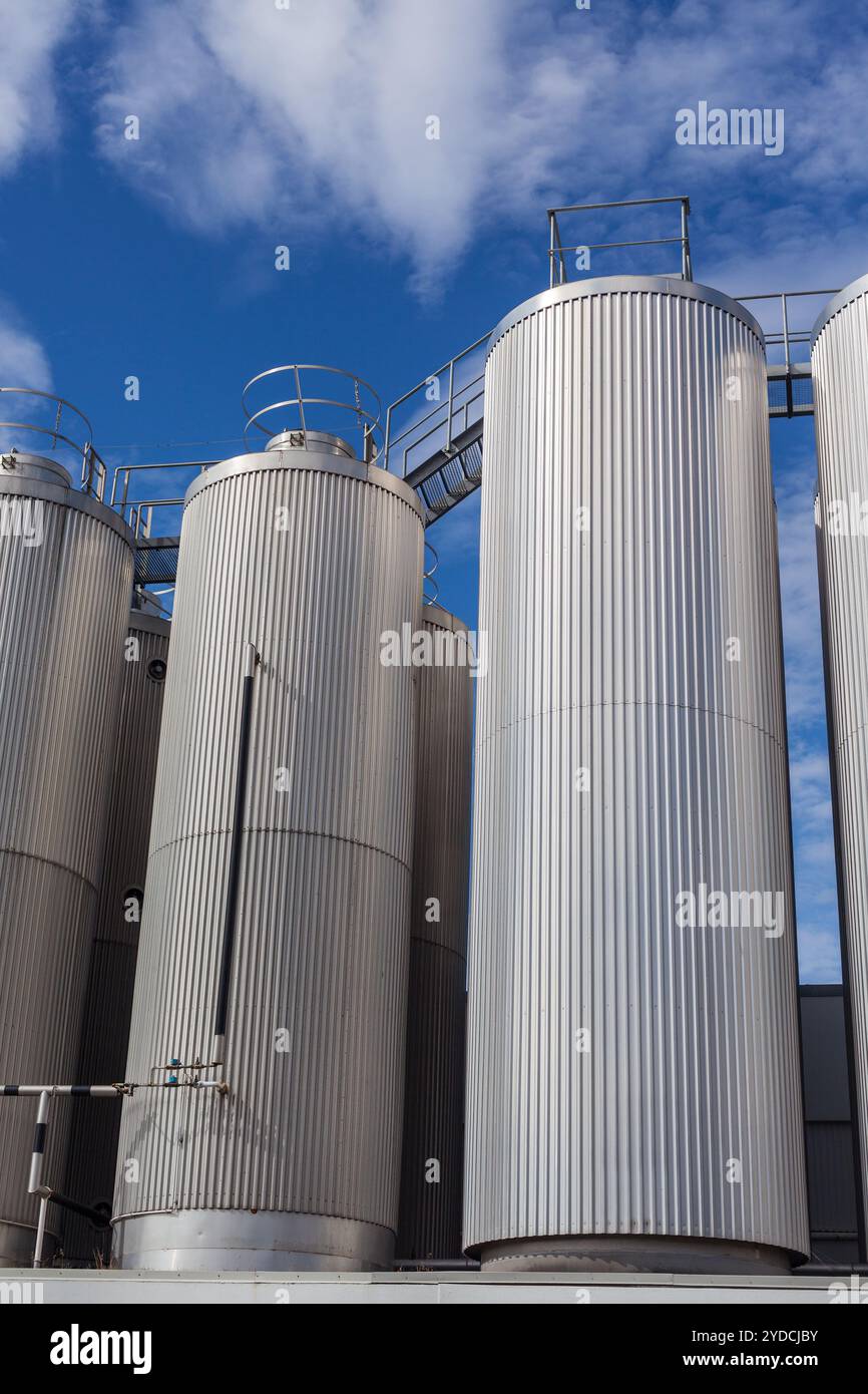 Giant industrial tanks on the bright blue sky Stock Photo - Alamy