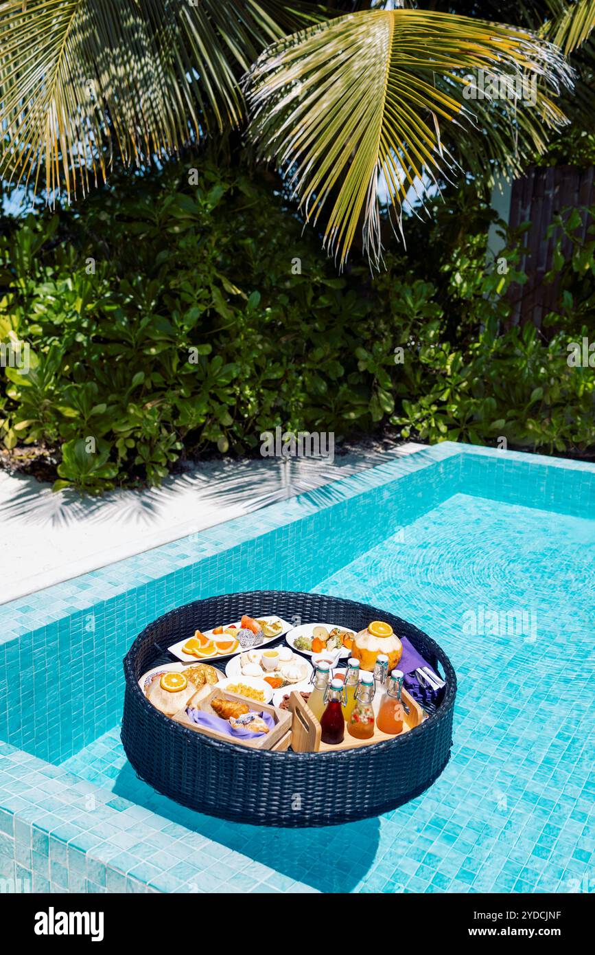 A floating breakfast tray with various dishes and drinks is located in ...