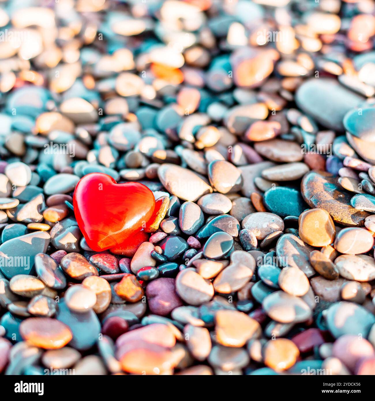 Romantic symbol of red heart on the pebble beach Stock Photo - Alamy
