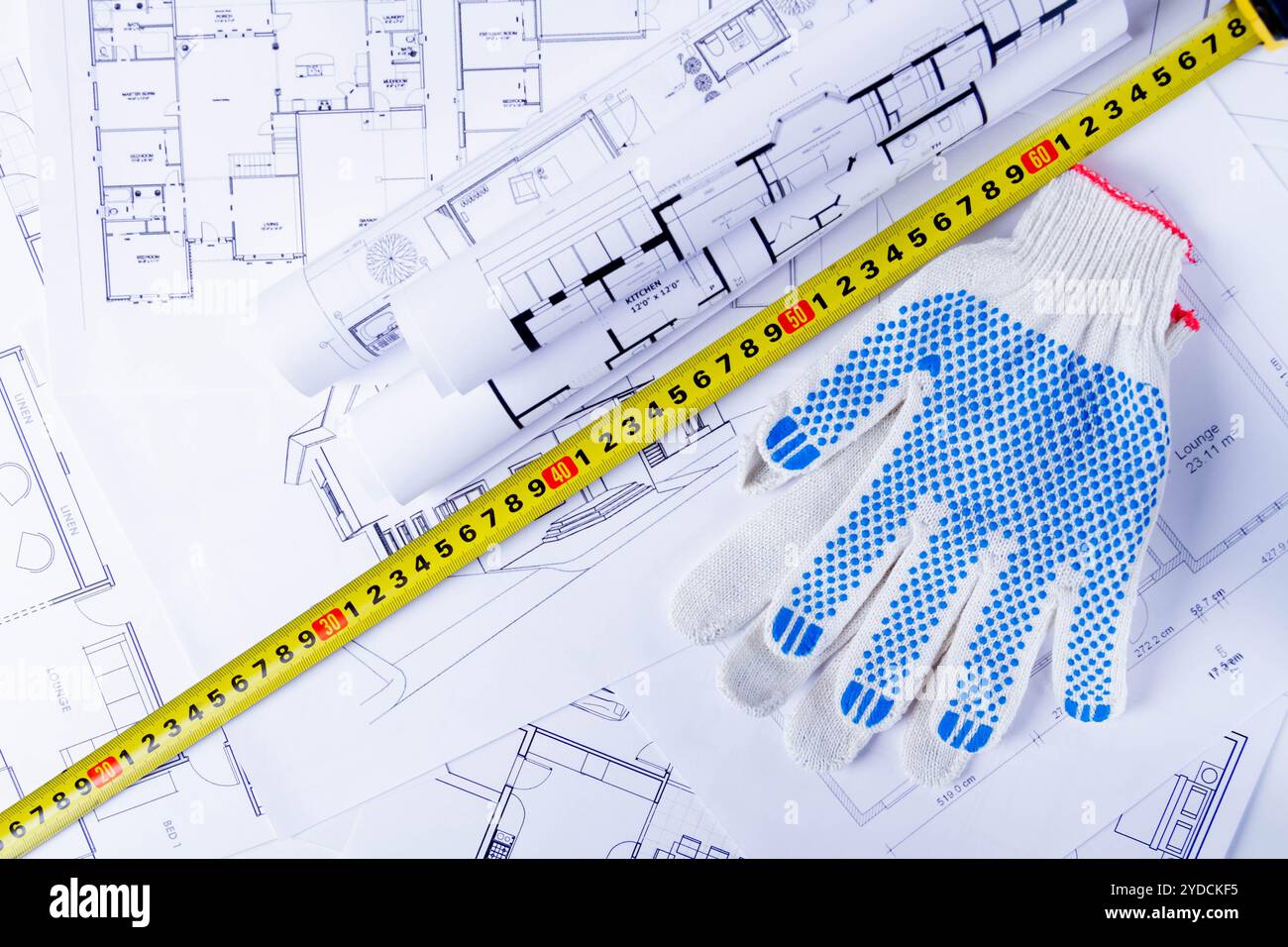 Builder's tools on the scheme of the house. Preparing to build a house ...