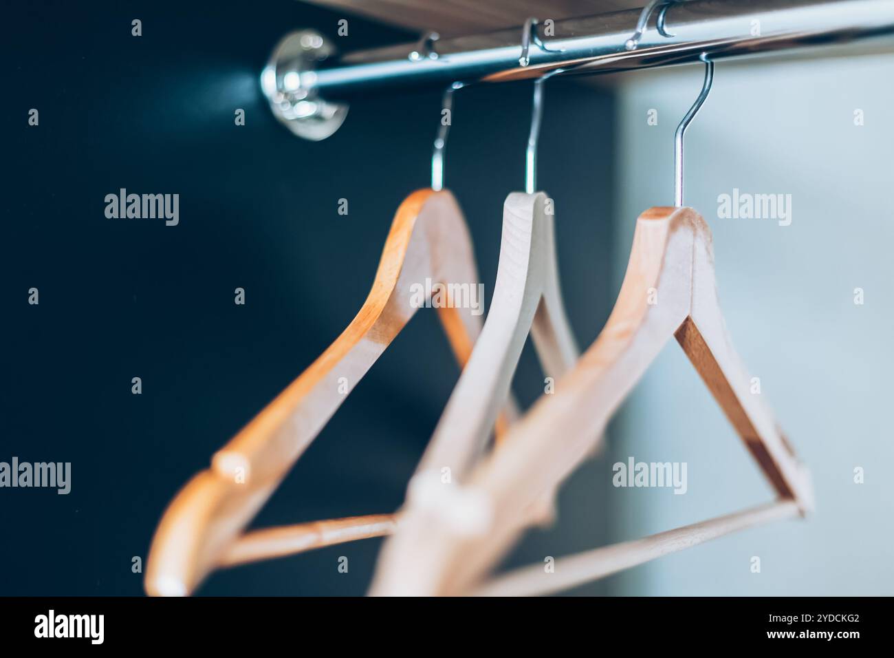 Empty Wooden hangers on rail in closet Stock Photo - Alamy
