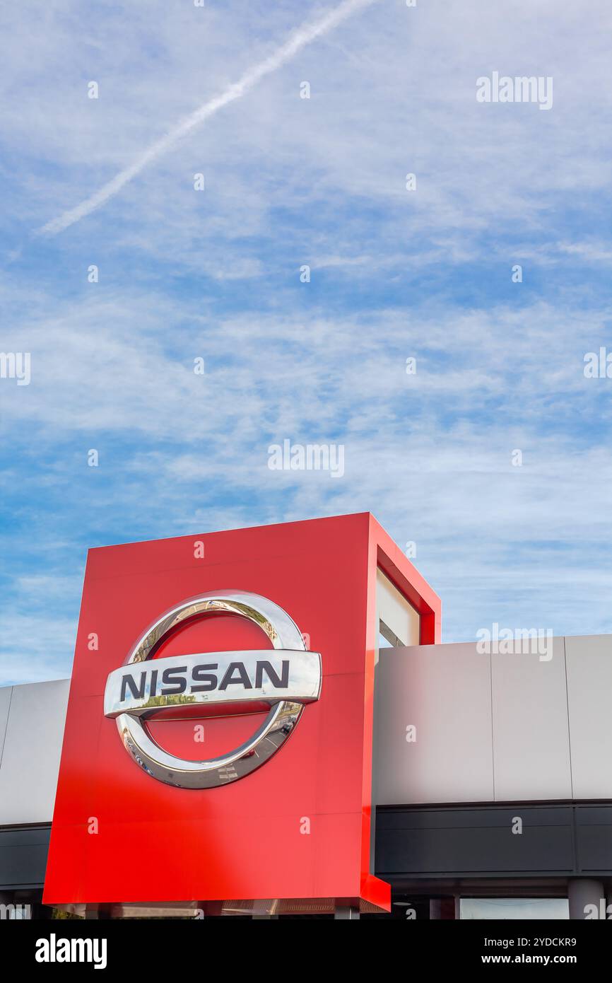 Nissan brand logo on bright blue sky background Stock Photo - Alamy