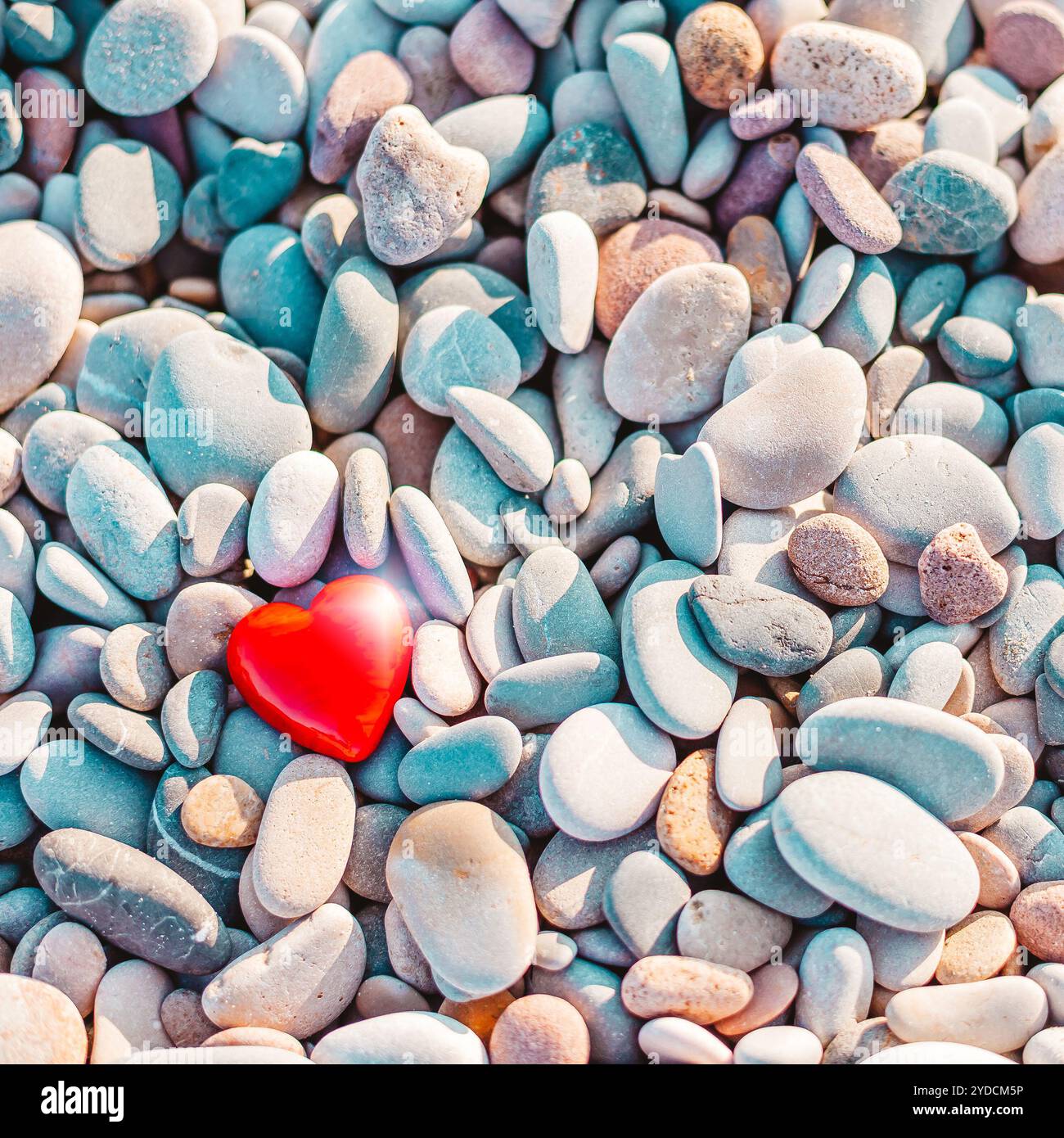 Romantic symbol of red heart on the pebble beach Stock Photo - Alamy