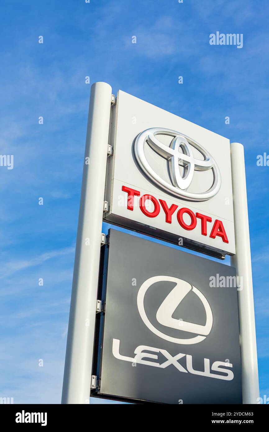 Toyota brand logo on bright blue sky background Stock Photo - Alamy