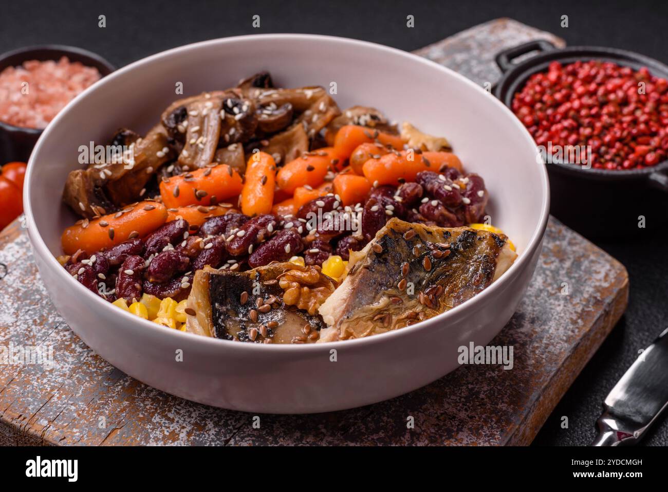 A colorful vegetarian dish consists of fish, beans, corn, mushrooms ...