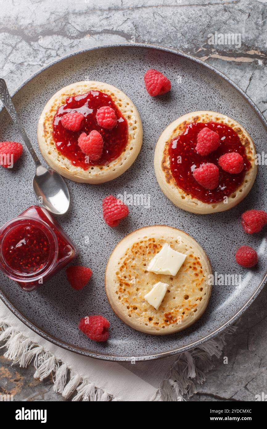 Sweet crumpet is a small griddle bread with butter and raspberry jam ...