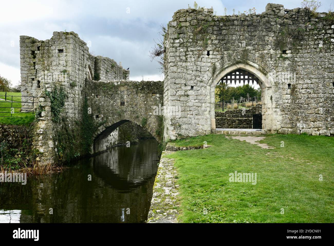 Ruins of The Medieval Barbican and Mill at Leeds castle under a grey ...