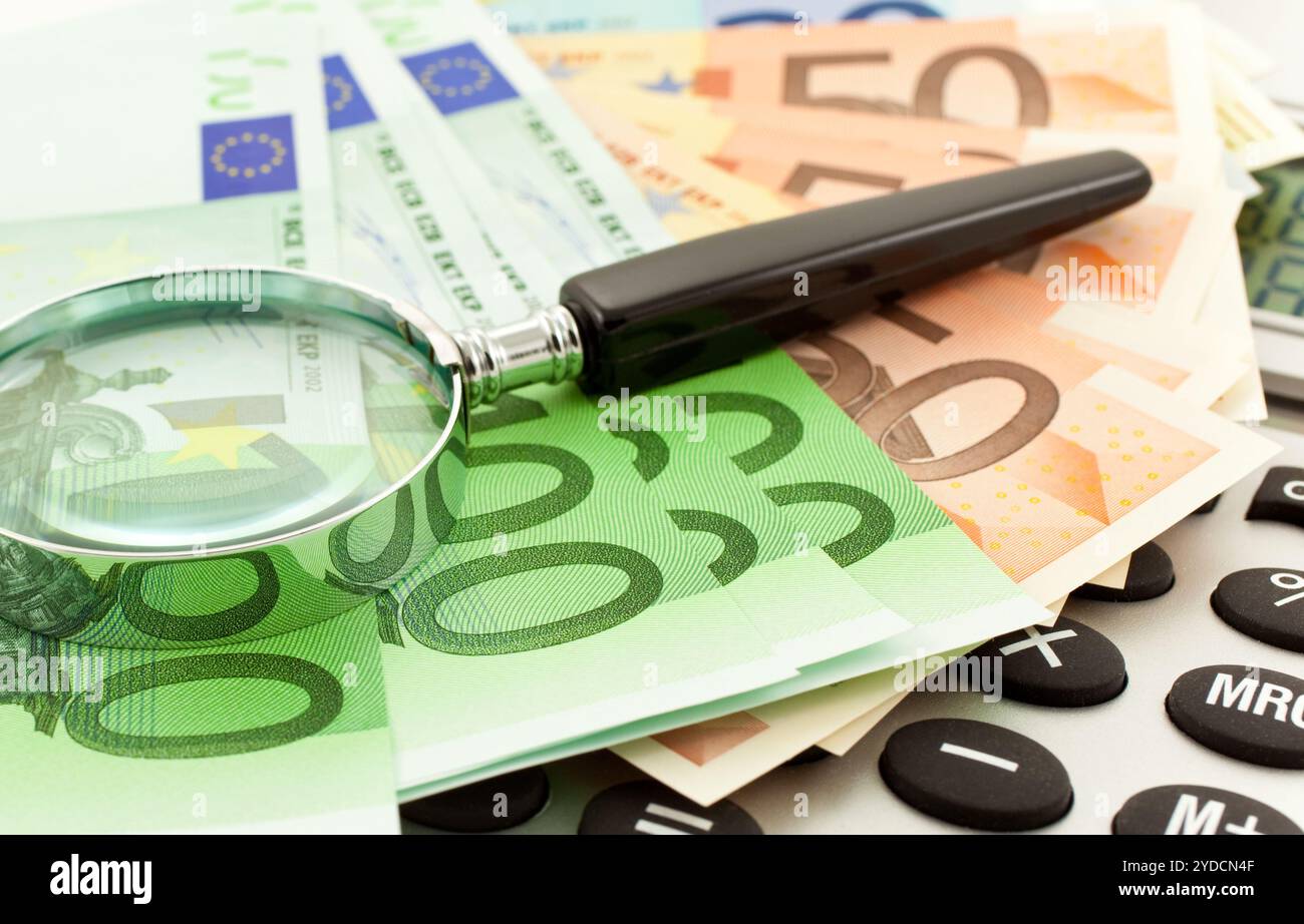 Euro Notes with calculator and magnifier Stock Photo - Alamy