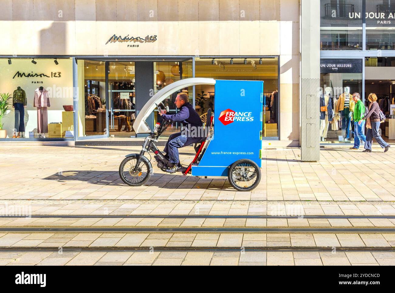 France Express delivery man riding electric-powered trike on city ...
