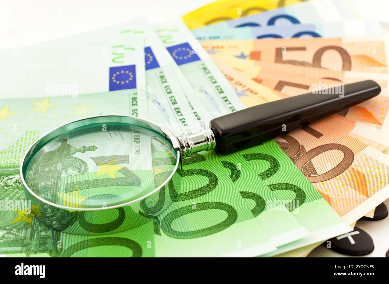 Euro Notes with calculator and magnifier Stock Photo - Alamy