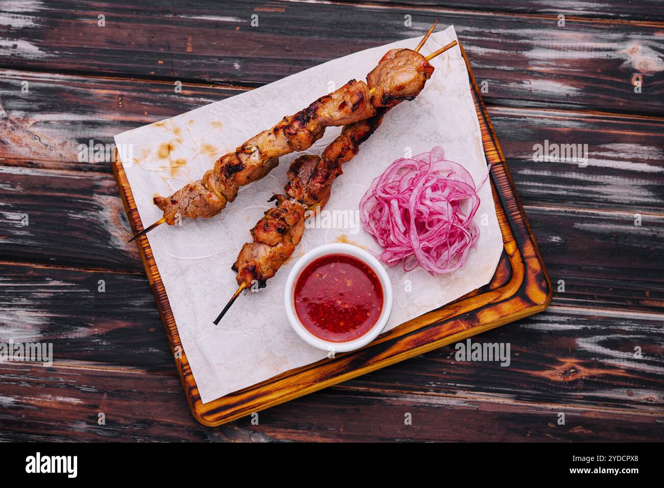 Pork kebab on a wooden skewer and red onion Stock Photo - Alamy