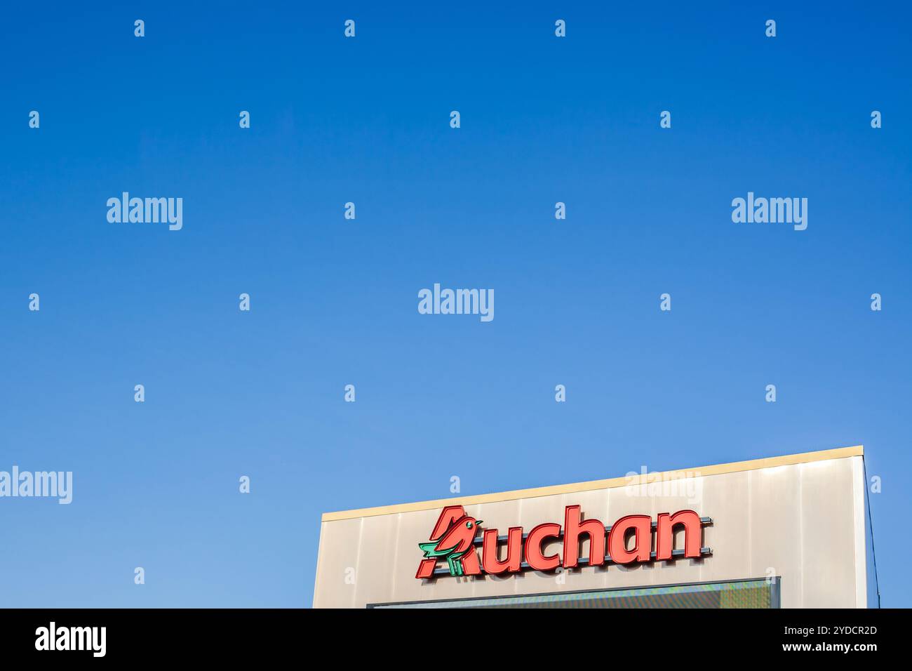 Auchan Supermarket logo at its store building Stock Photo - Alamy