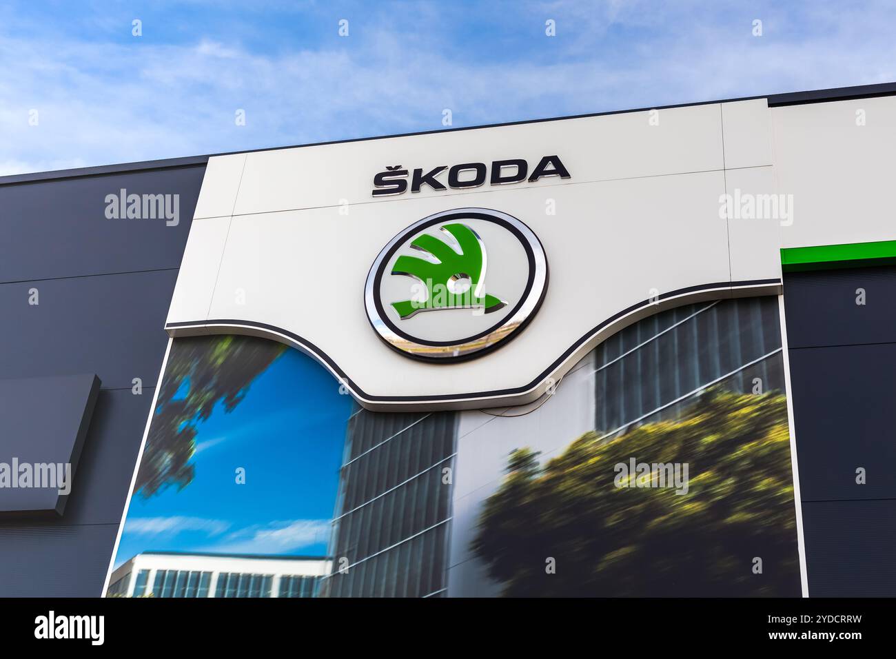 Skoda brand logo on bright blue sky background Stock Photo - Alamy