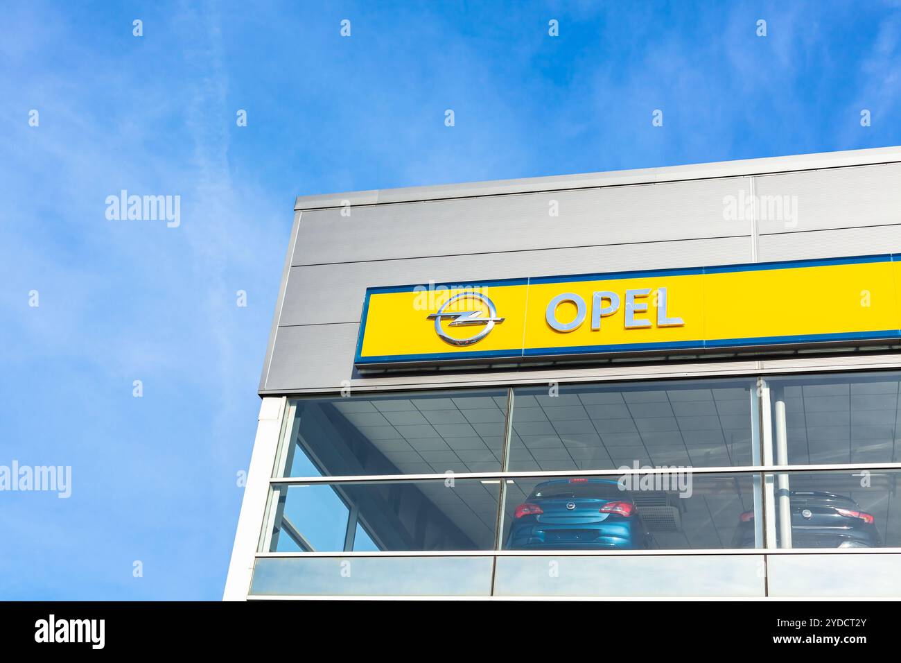 Opel brand logo on bright blue sky background Stock Photo - Alamy