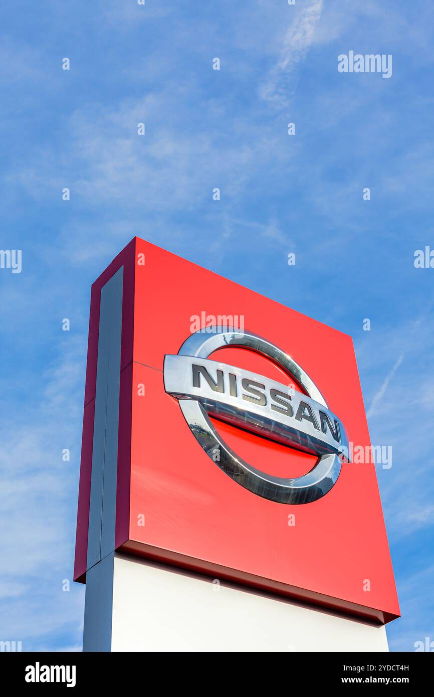 Nissan brand logo on bright blue sky background Stock Photo - Alamy