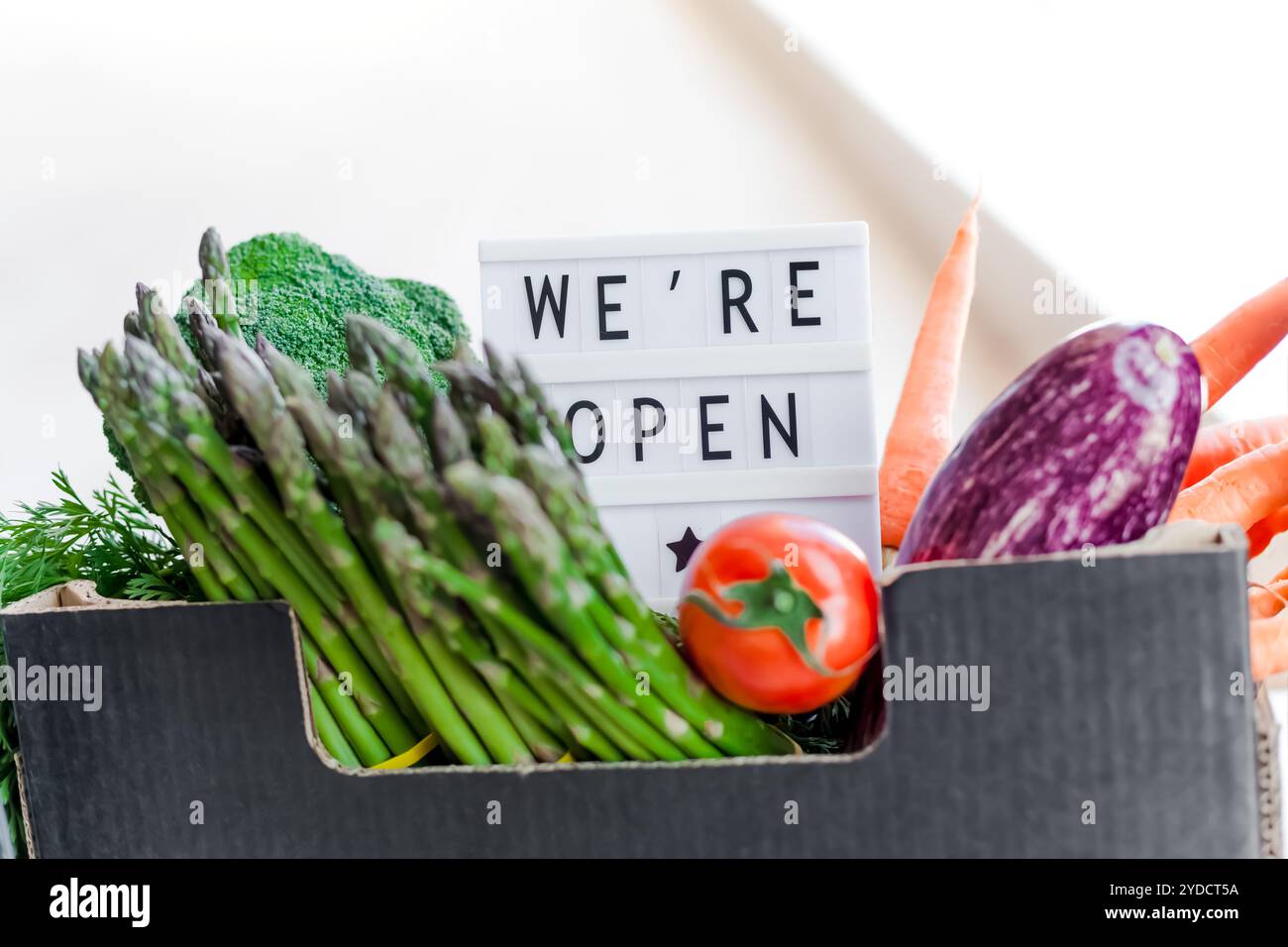 Text We're open and Fresh green and vegetables box Stock Photo - Alamy
