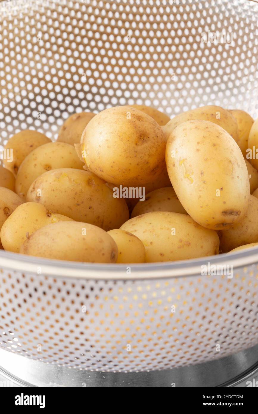 Boiled whole new potatoes in a stainless steel colander strainer ...