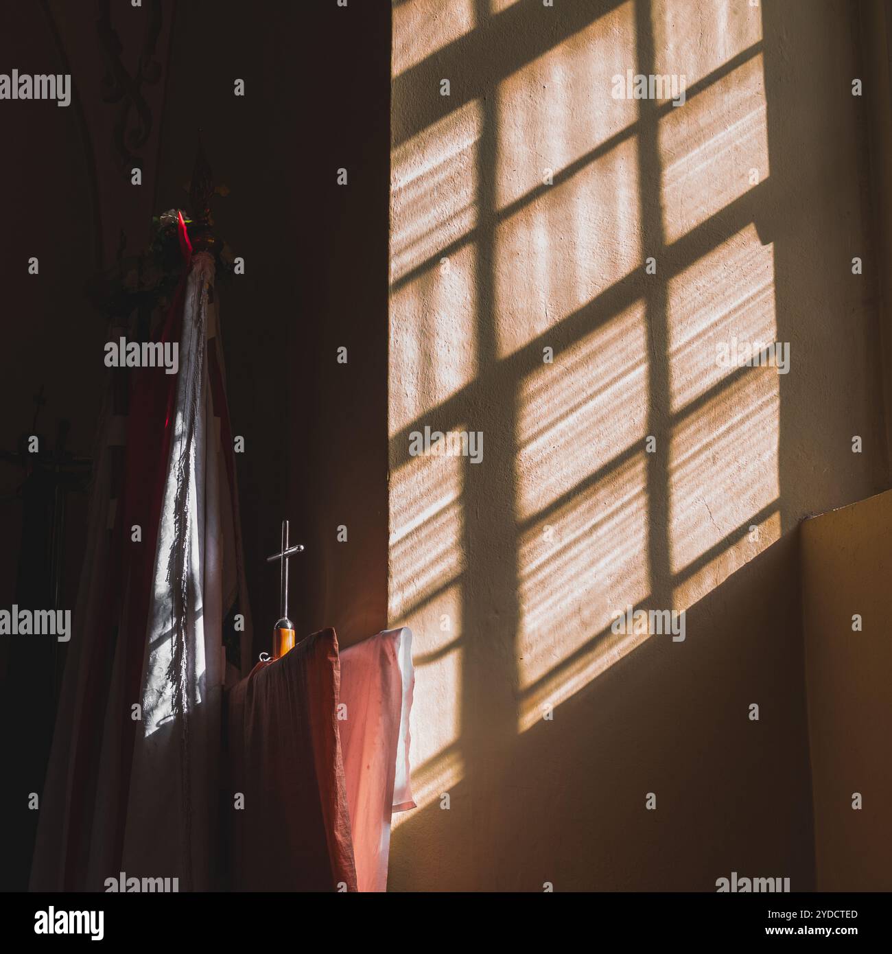 light from a church window falling on a cross - concept photography in ...