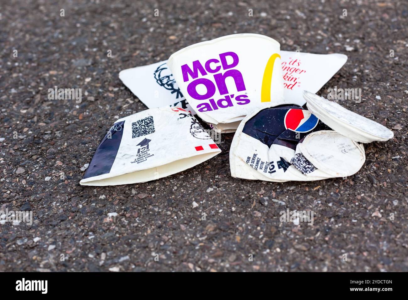 Disposable fast food cups garbage on asphalt road Stock Photo - Alamy
