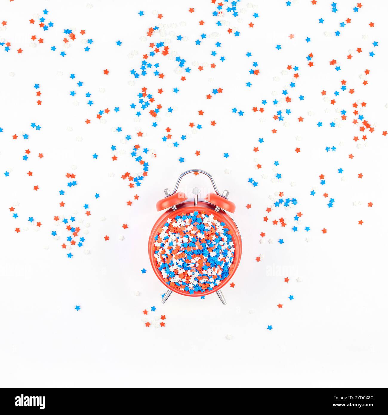 Alarm clock, red blue and white stars confetti Stock Photo - Alamy