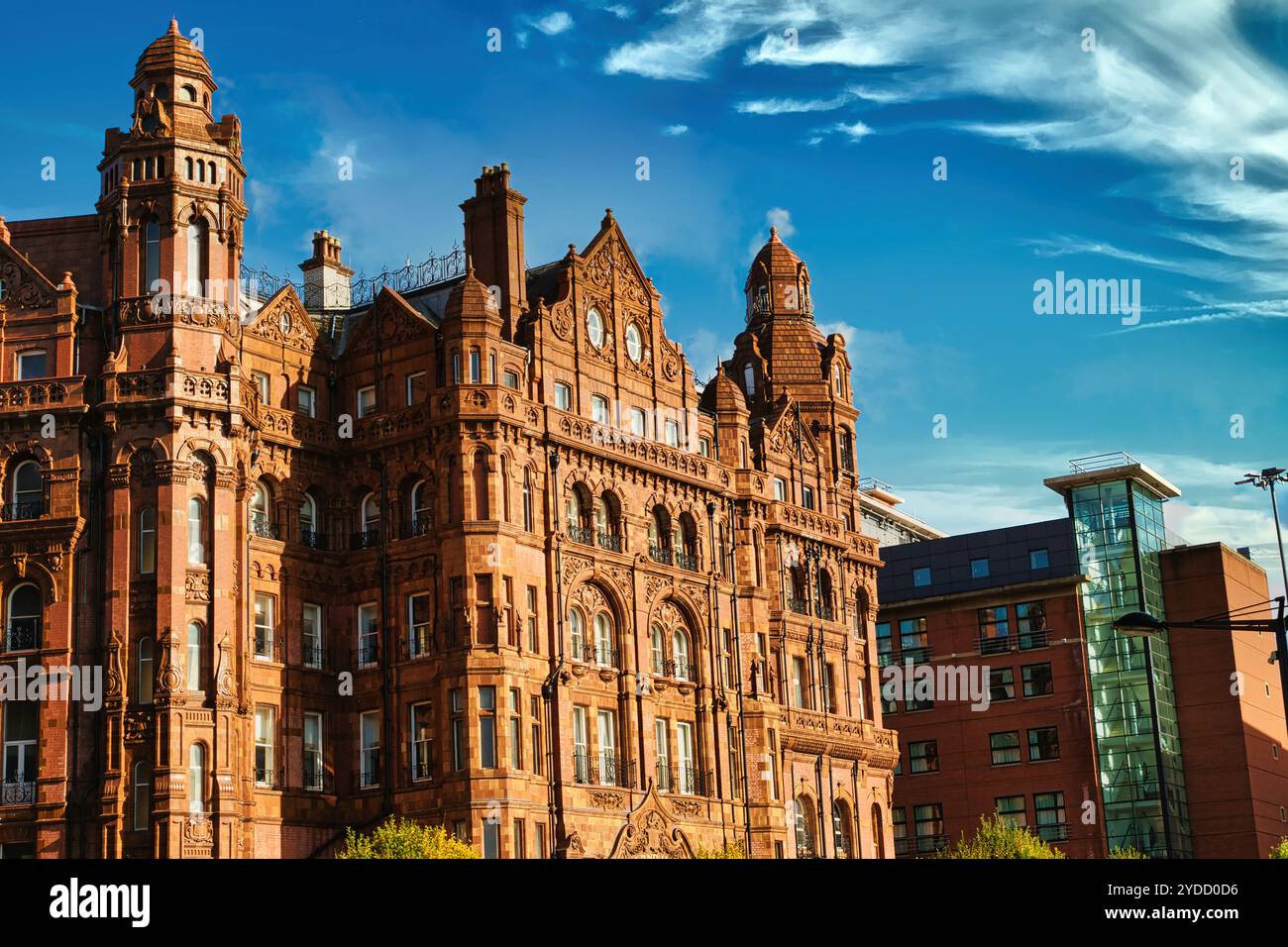 A tall, ornate brick building with multiple towers and turrets ...