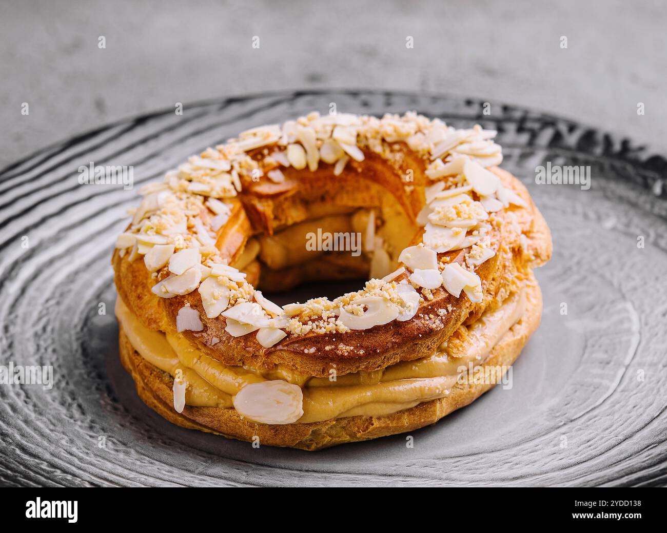 Round cake with mendal and custard Stock Photo - Alamy