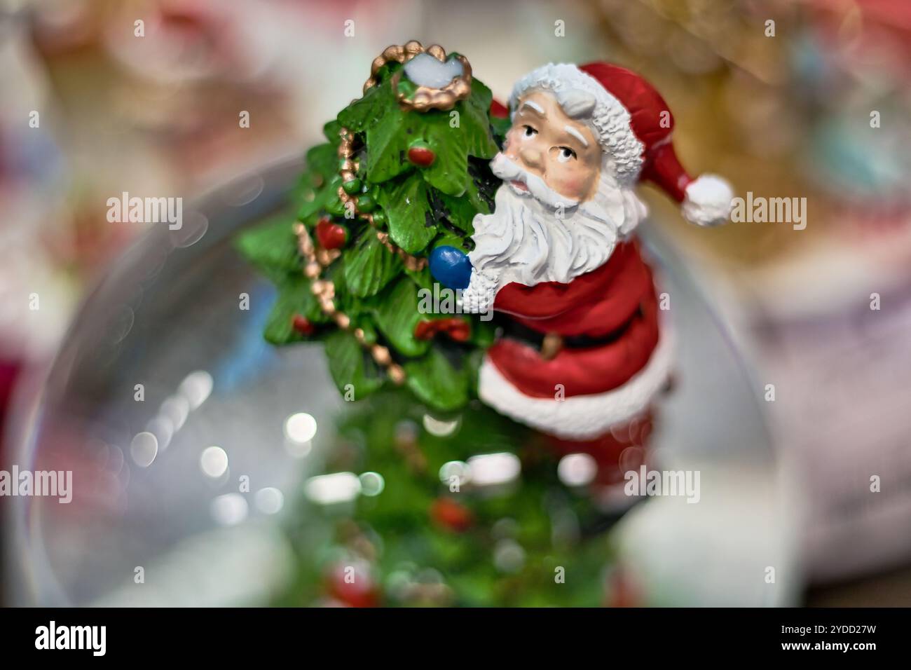 A close-up view of a Santa Claus figurine inside a glass sphere ...