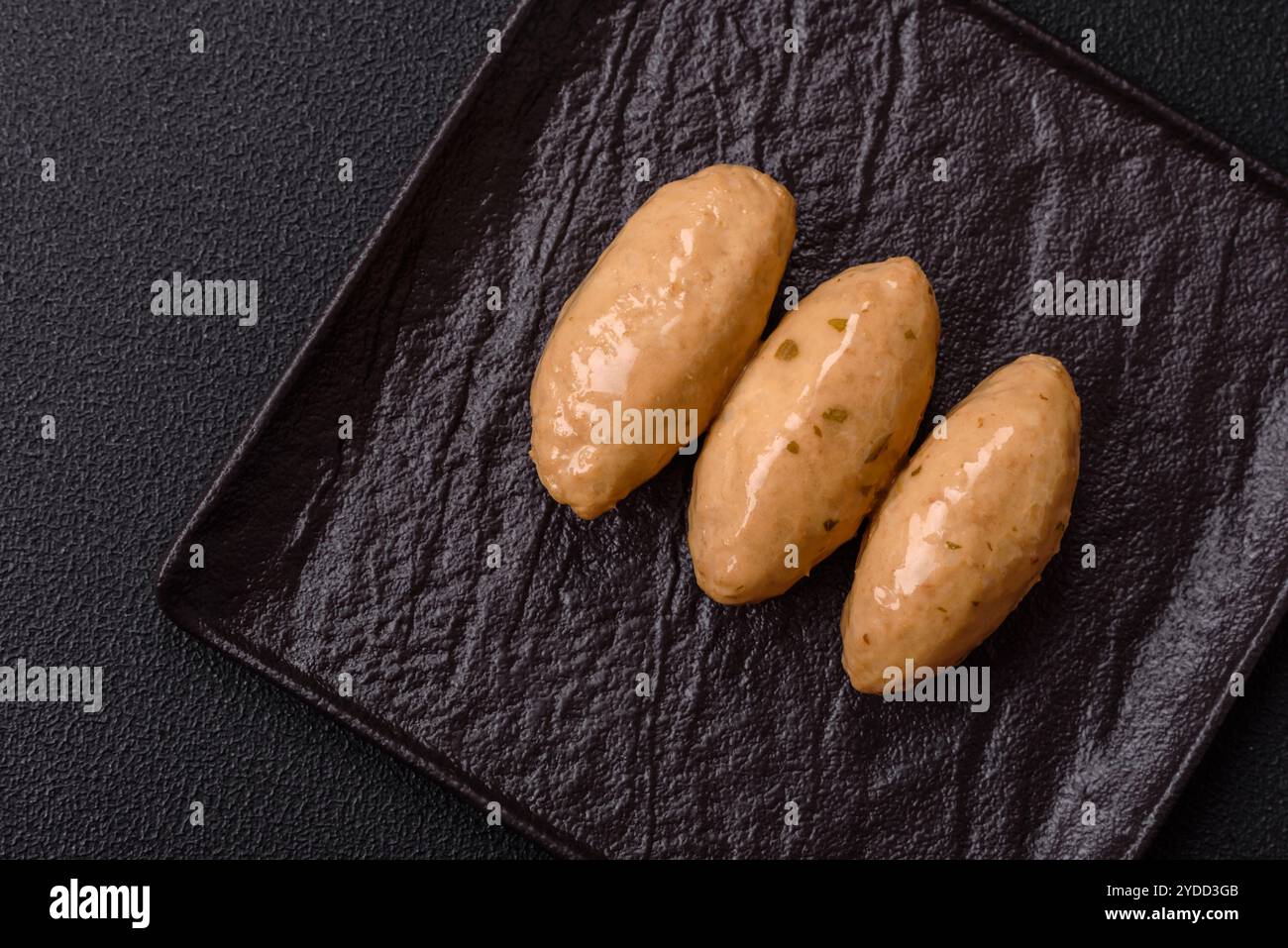 Fish or meat quenelles with delicate mushroom sauce, salt and spices Stock Photo - Alamy