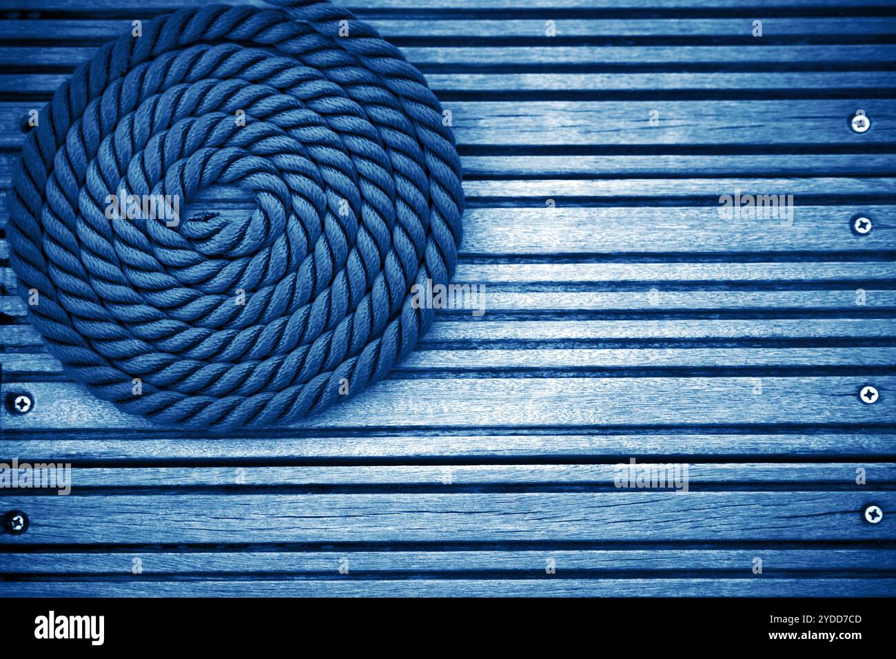 Nautical mooring rope blue toned background Stock Photo - Alamy