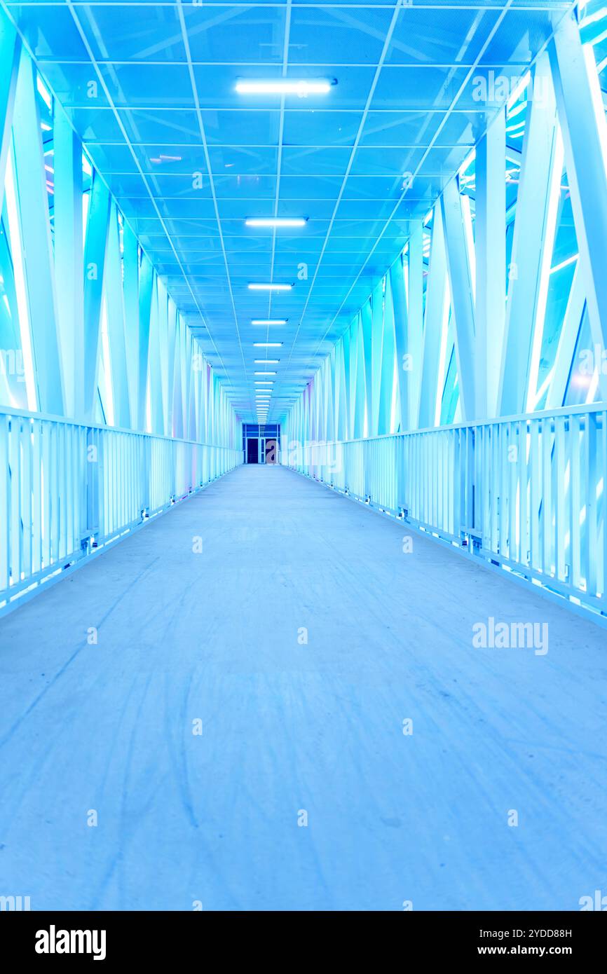A futuristic illuminated walkway with a symmetrical design and glowing ...