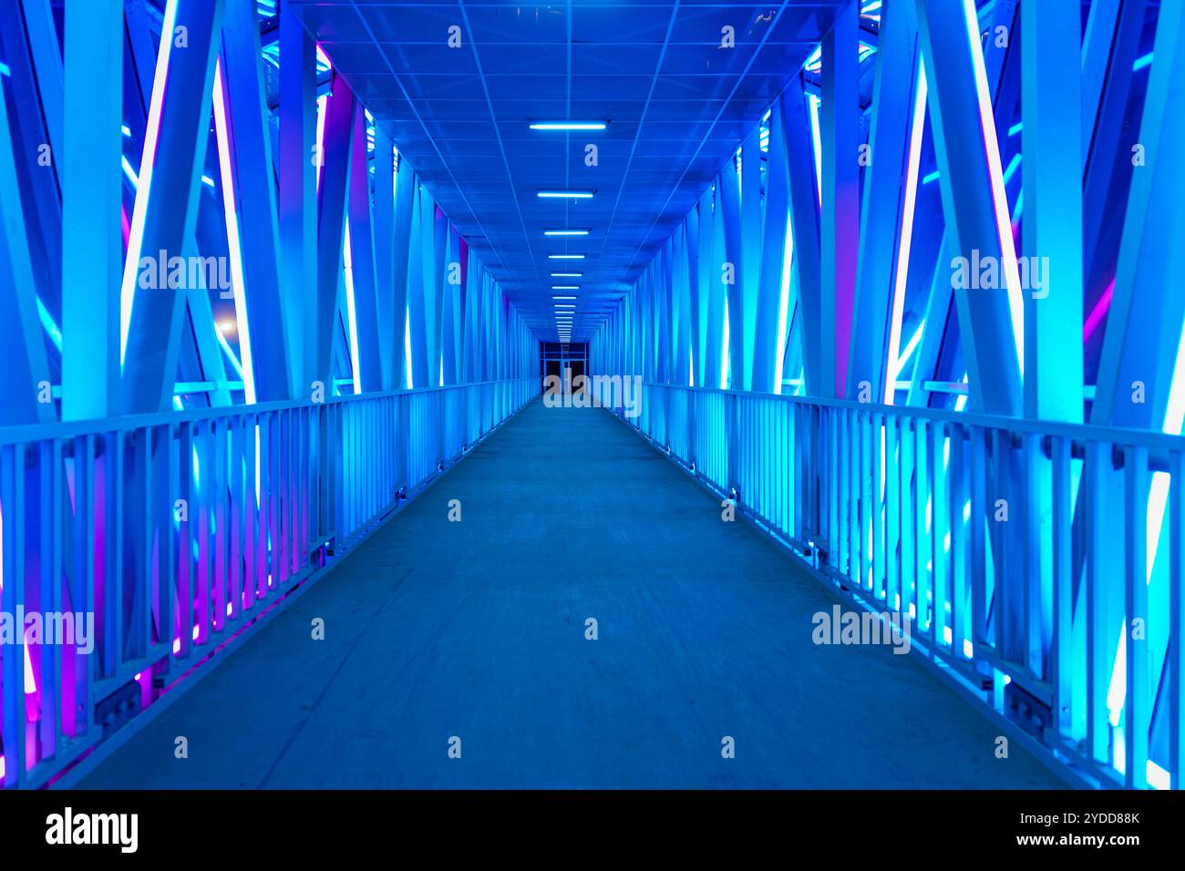 A futuristic illuminated walkway with a symmetrical design and glowing ...