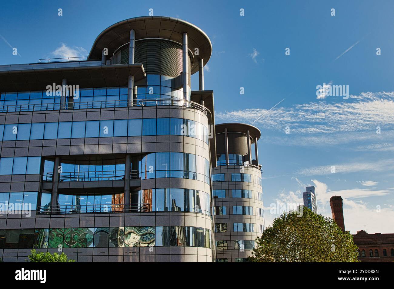 Two modern office buildings with a rounded, curved design and many ...