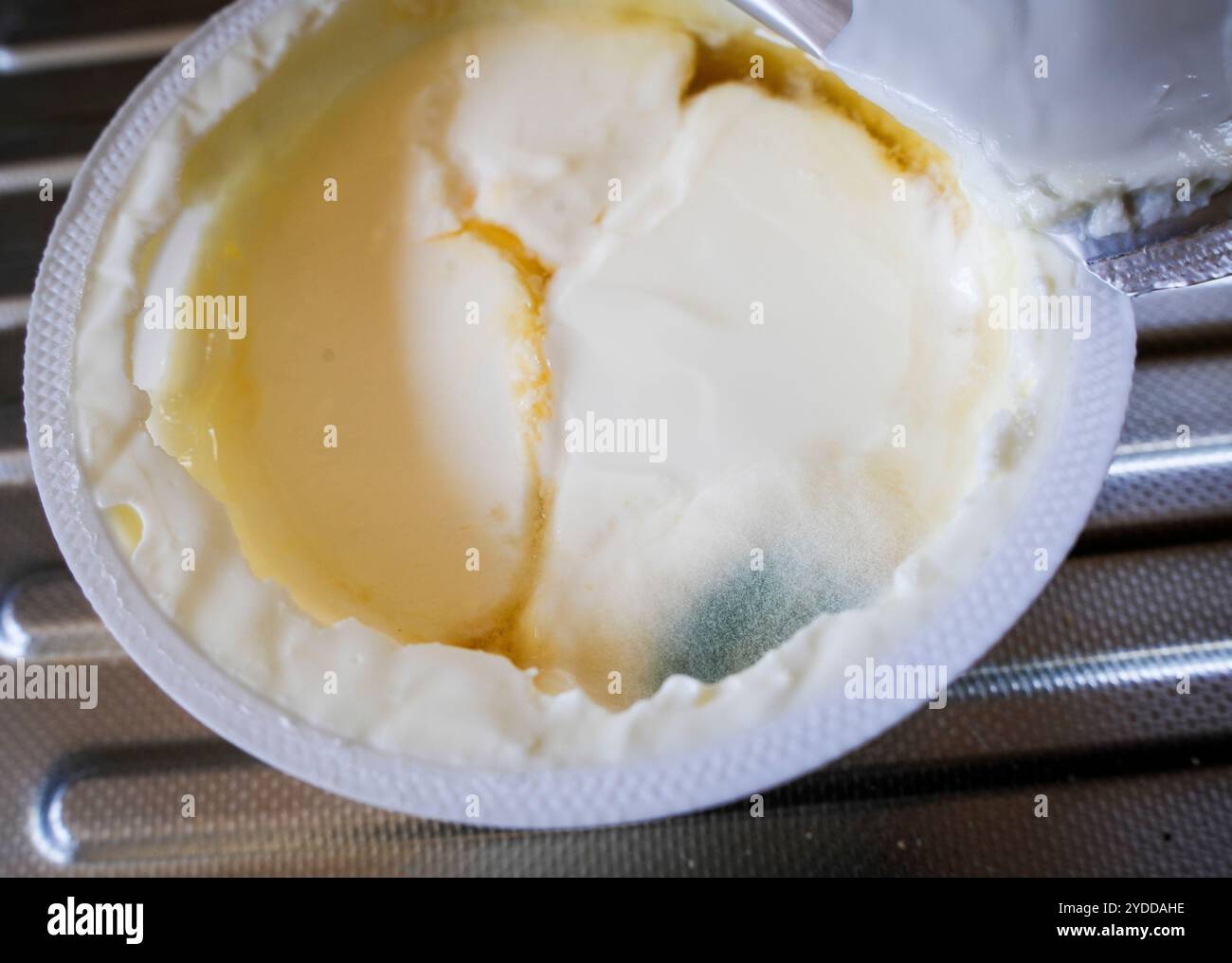 Product shoot detail close up of moldy uneadable yogurt in plastic ...