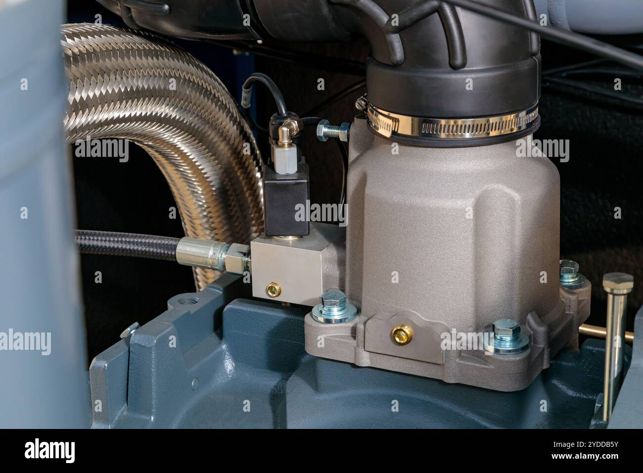 Close-up of an industrial air compressor pump featuring a flexible ...