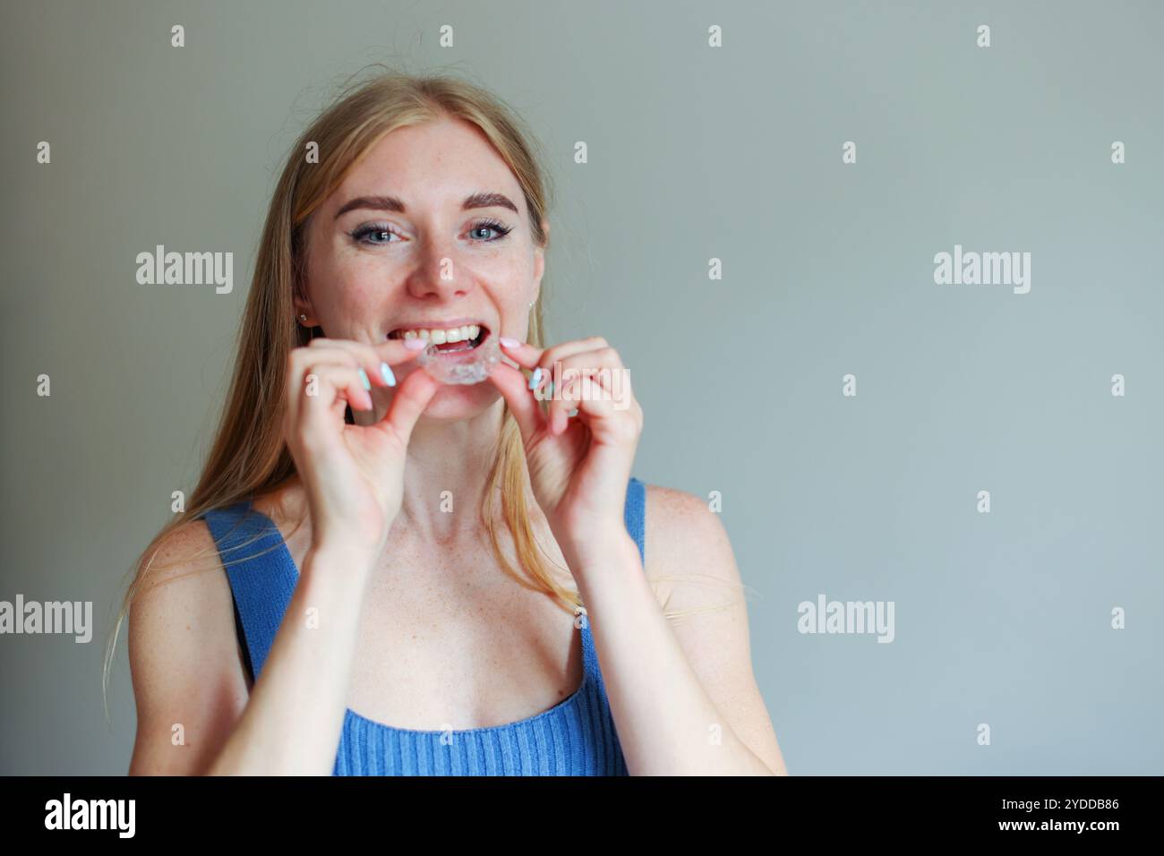 Woman wearing orthodontic silicone trainer. Invisible braces aligner ...