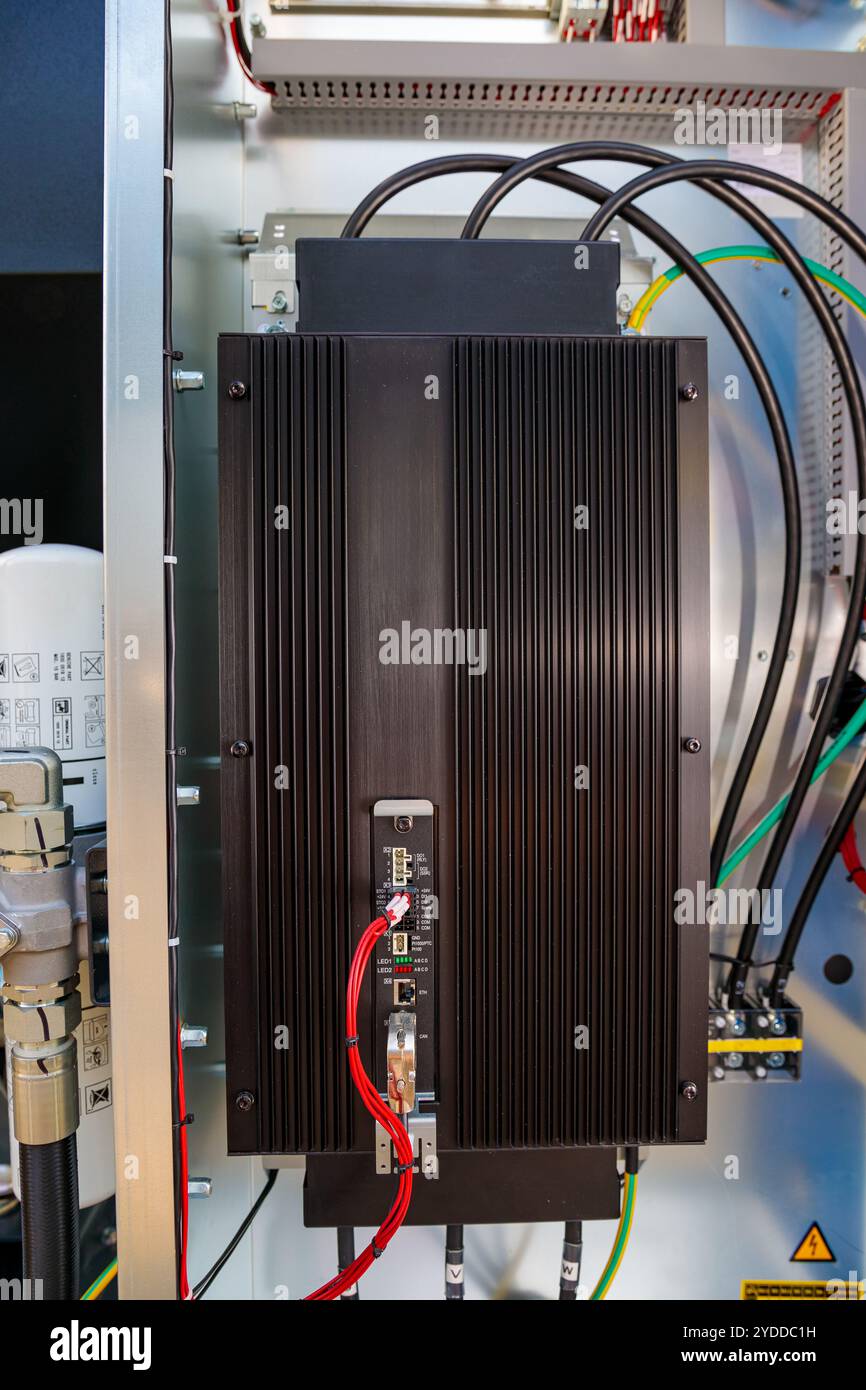 Electronic frequency converter with cooling fins and cables, mounted ...