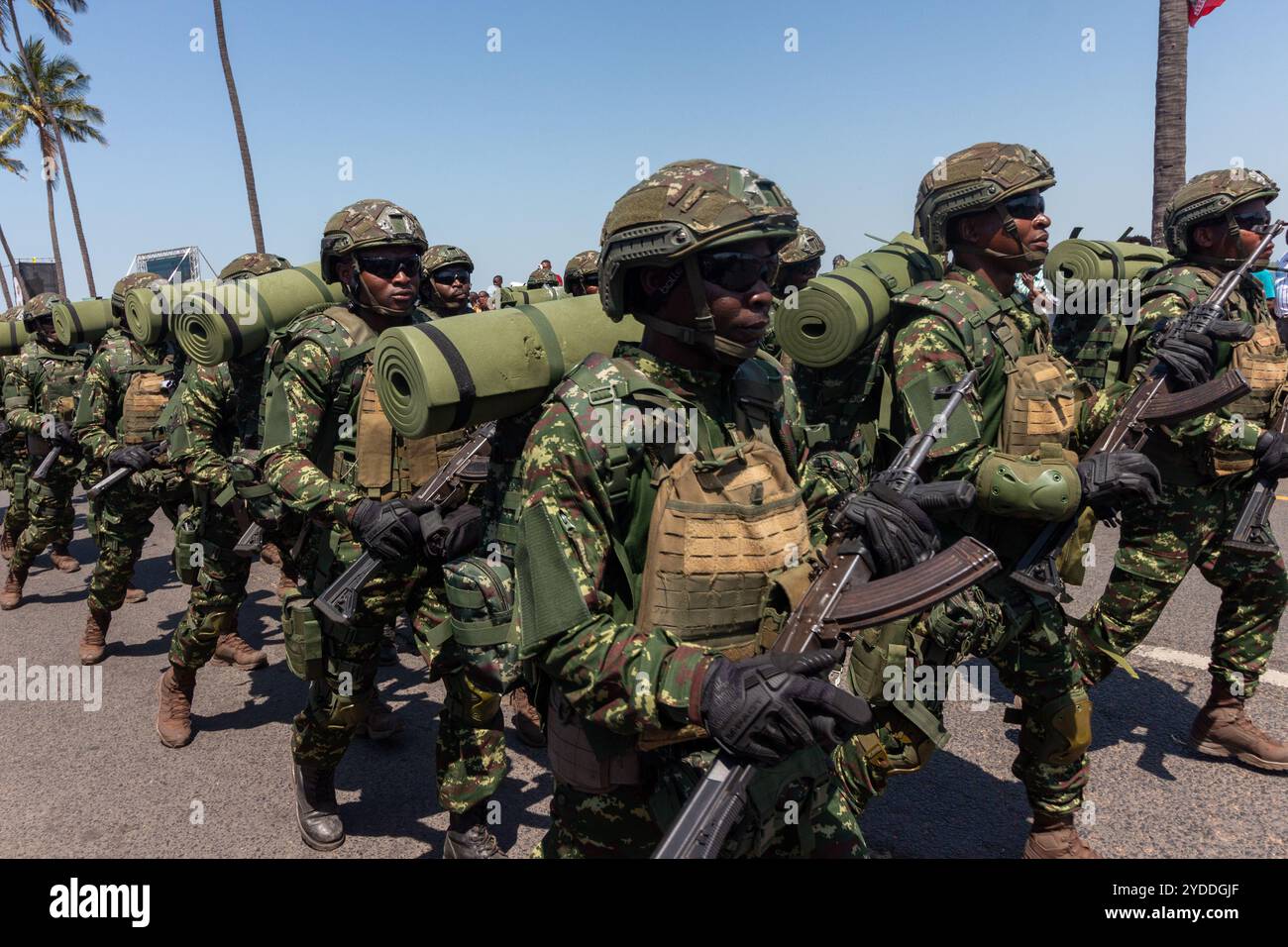 African Soldiers Marching with Bedrolls and Combat Weapons on a City ...