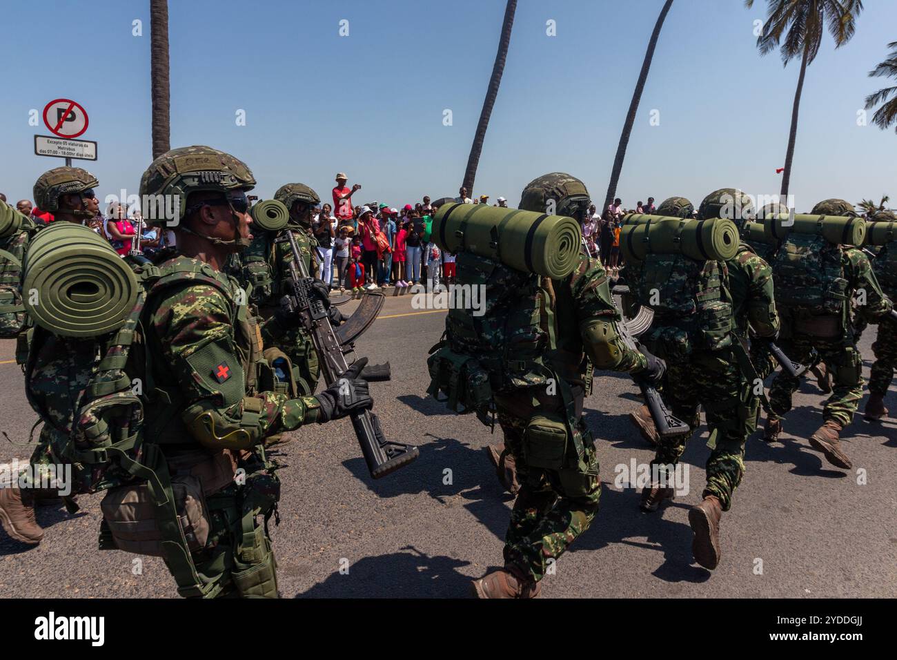 African Soldiers Marching with Bedrolls and Combat Weapons on a City ...