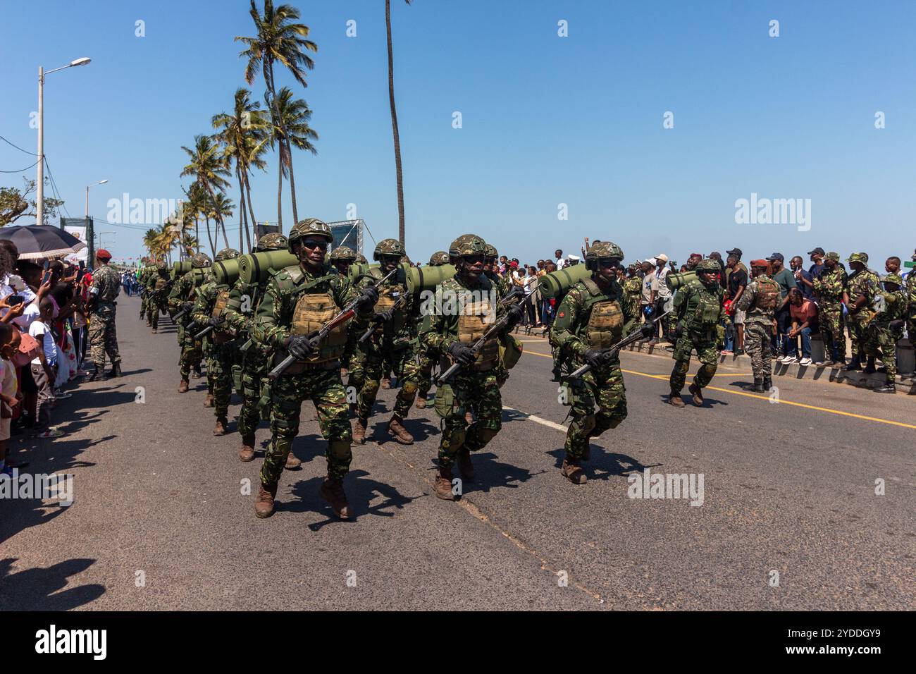 African Soldiers Marching with Bedrolls and Combat Weapons on a City ...