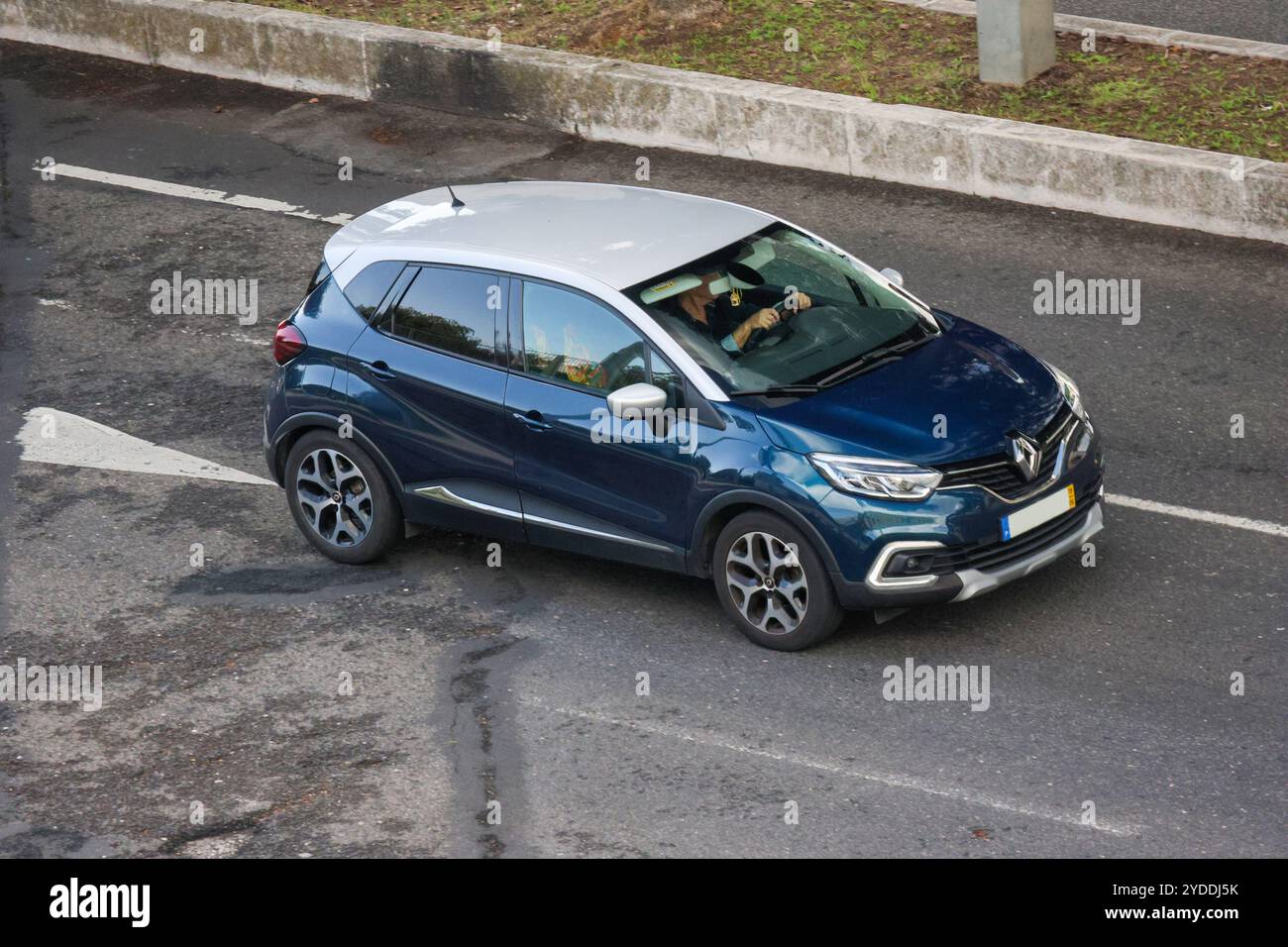 Modern blue renault captur suv is being driven by a man in a city Stock ...