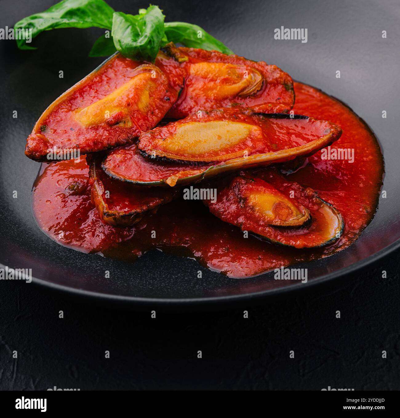 Cooked Mussels with hot spiced sauce Stock Photo - Alamy