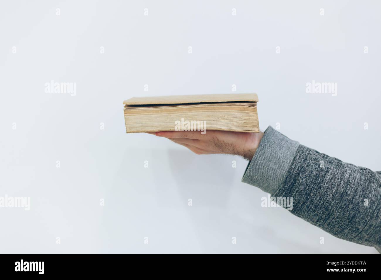 Holding book with one hand hi-res stock photography and images - Alamy