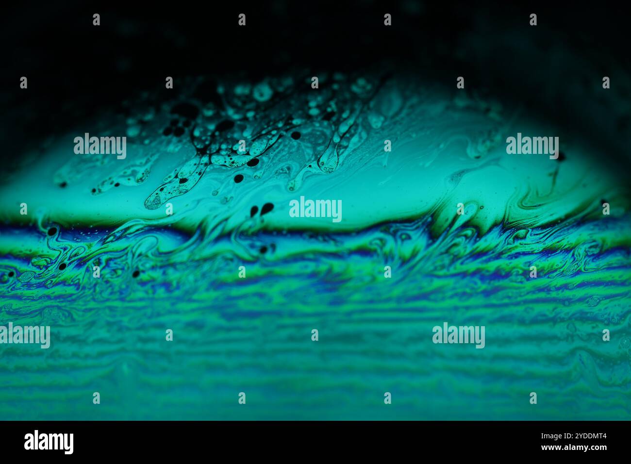 Bright rainbow reflection of liquid in macro, white colors ...