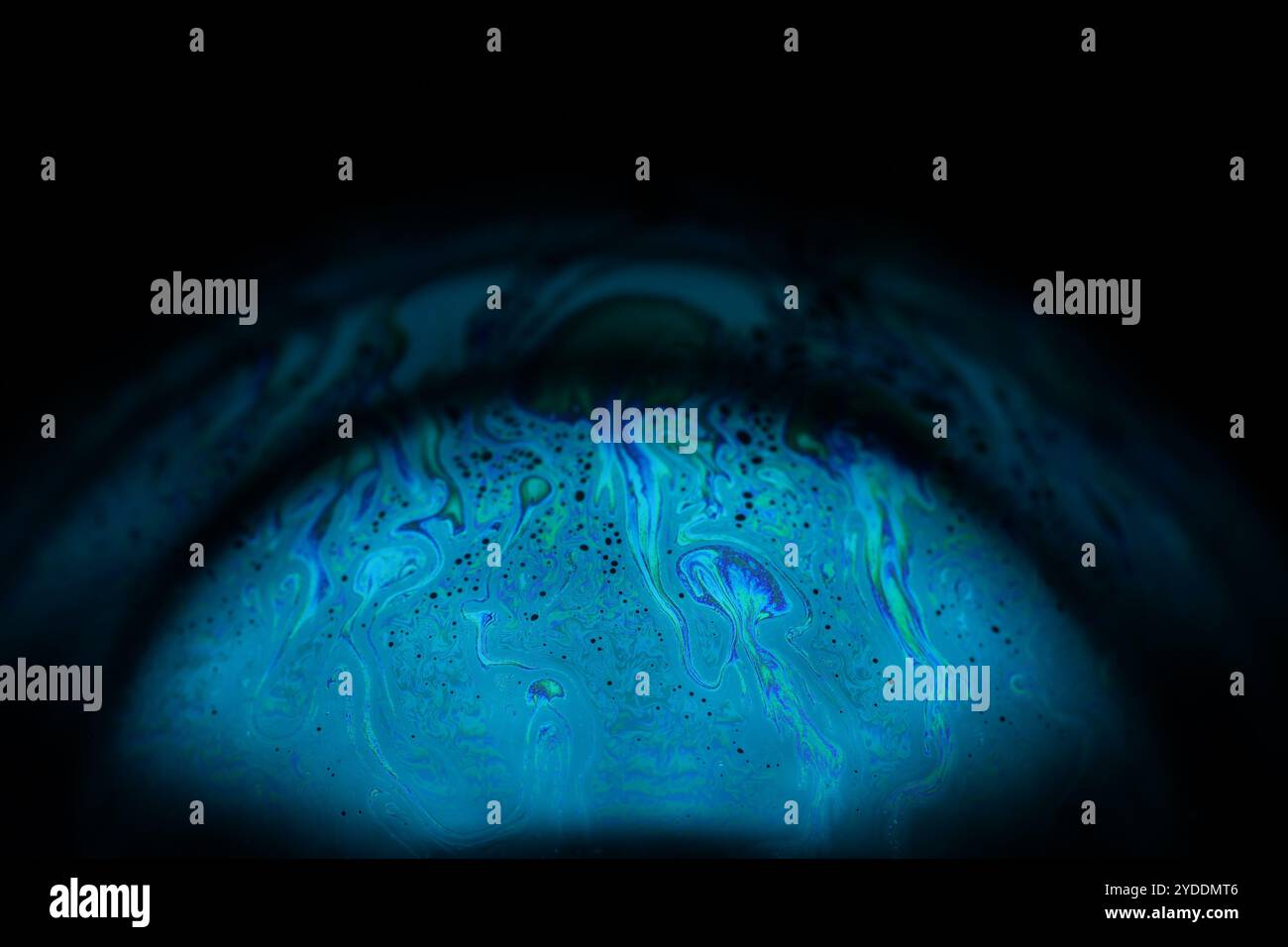 Bright blue liquid on black background, oil stains movement, bright ...