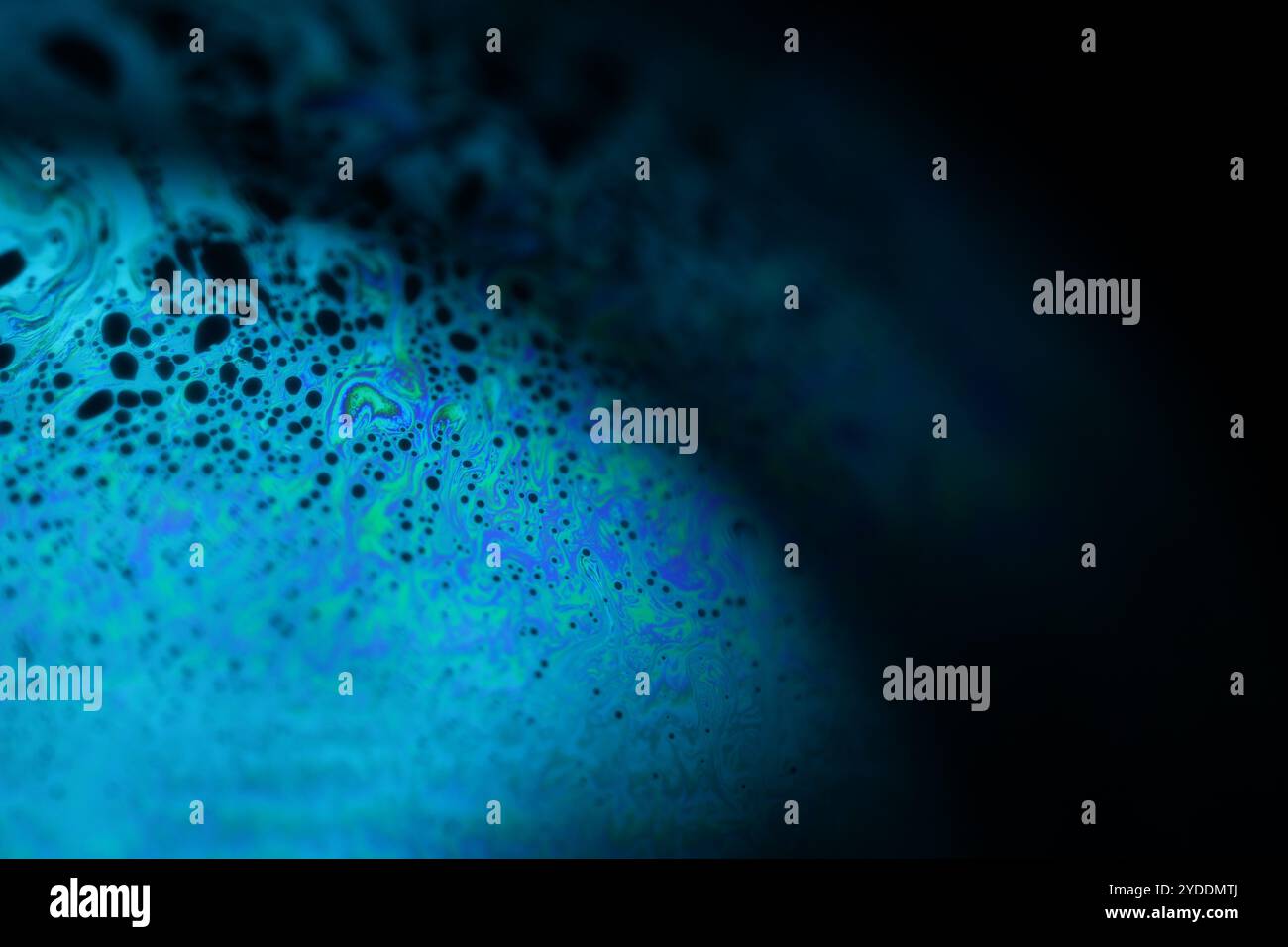 Bright blue liquid on black background, oil stains movement, bright ...