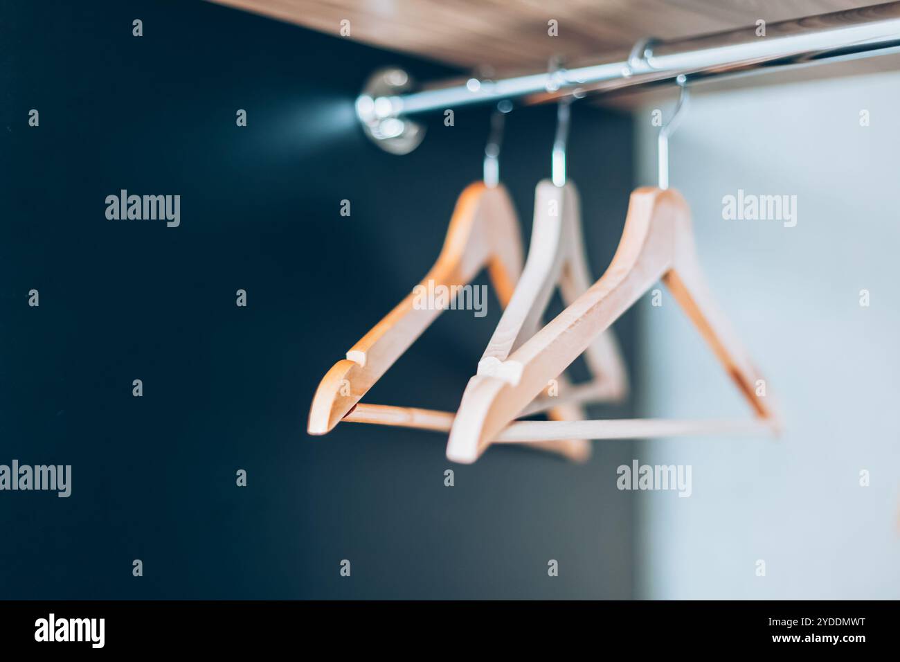 Empty Wooden hangers on rail in closet Stock Photo - Alamy