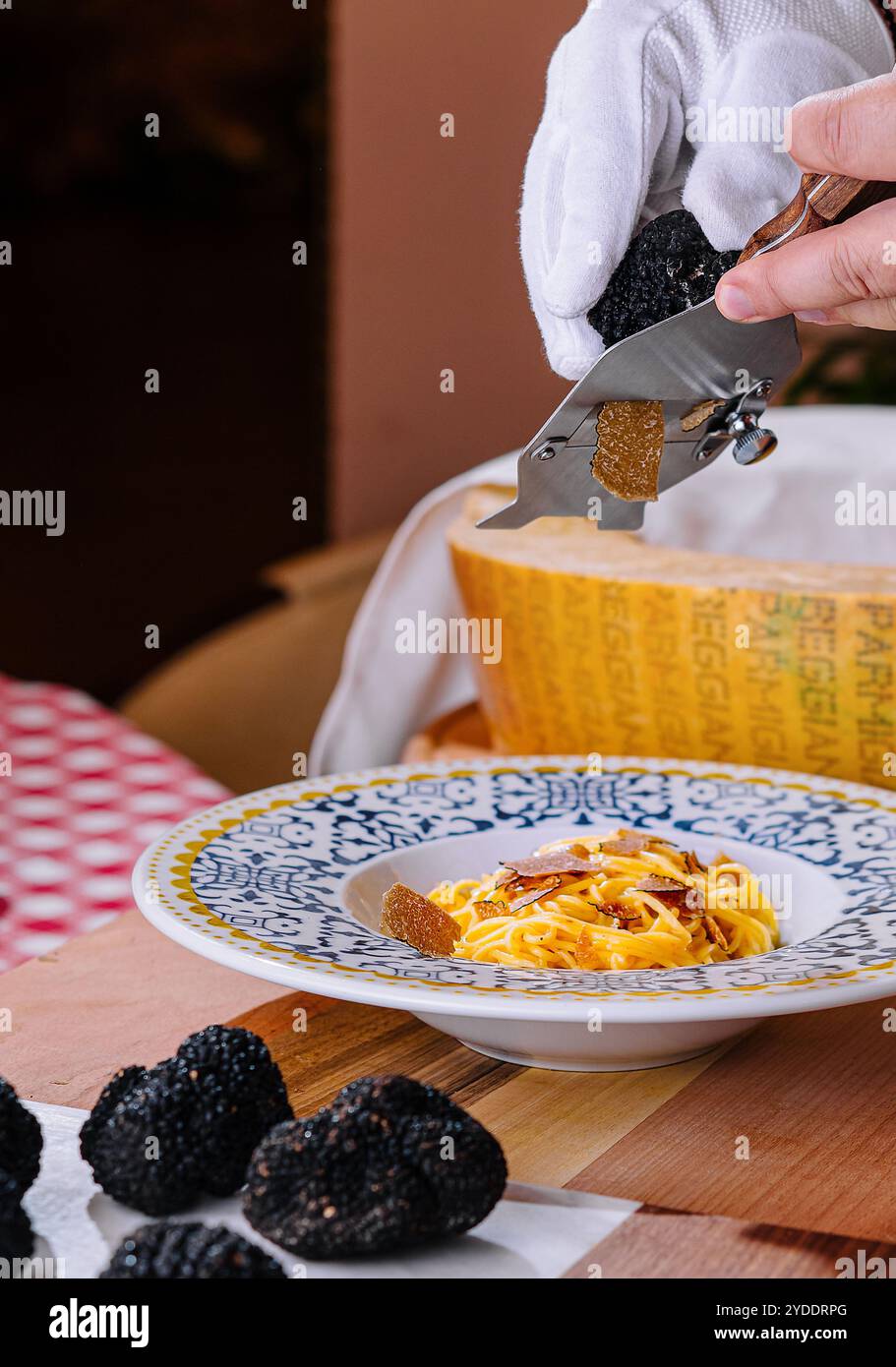 Chef Grating Truffle Shavings on Pasta with Parmesan Stock Photo - Alamy