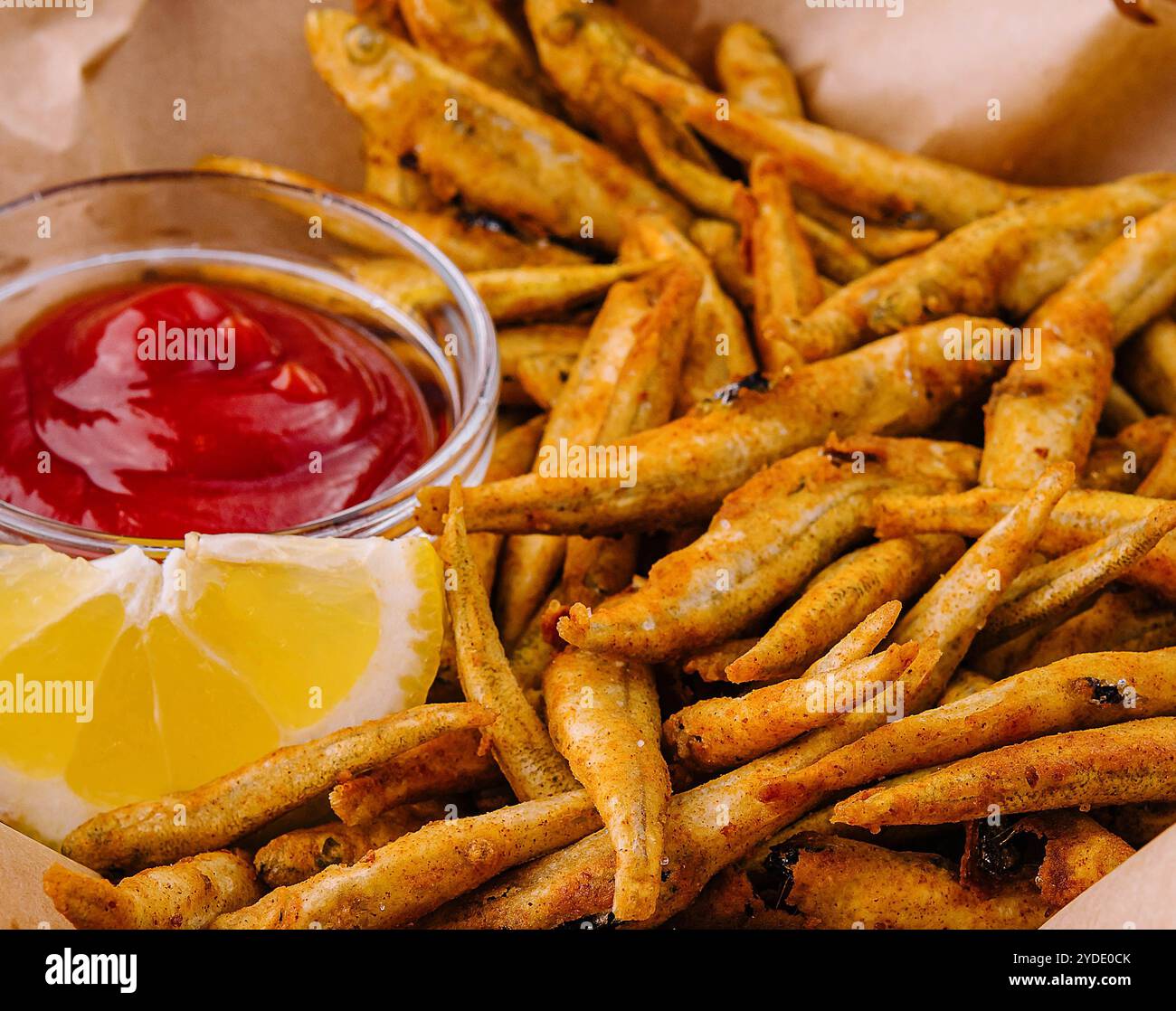 Fried fish with lemon and ketchup Stock Photo - Alamy